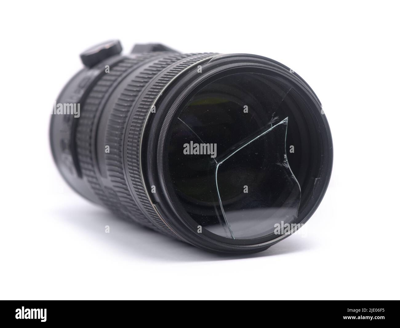 Broken protective filter glass on DSLR camera lens isolated on white ...