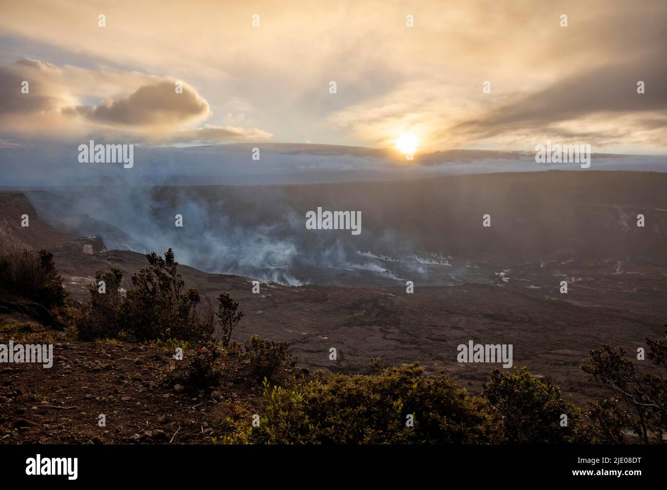 Sunset behind volcano Mauna Loa, active eruption of volcano Kilauea in ...