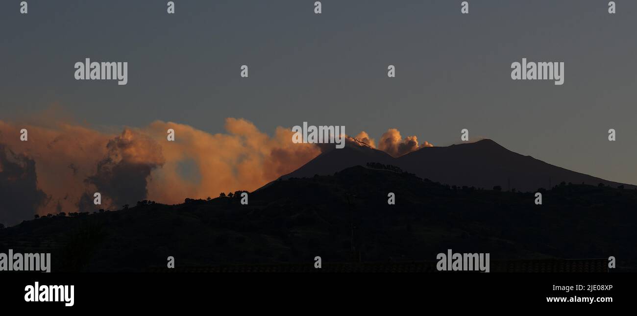 View of eruption cloud of the volcano Etna in the evening light, Sicily ...