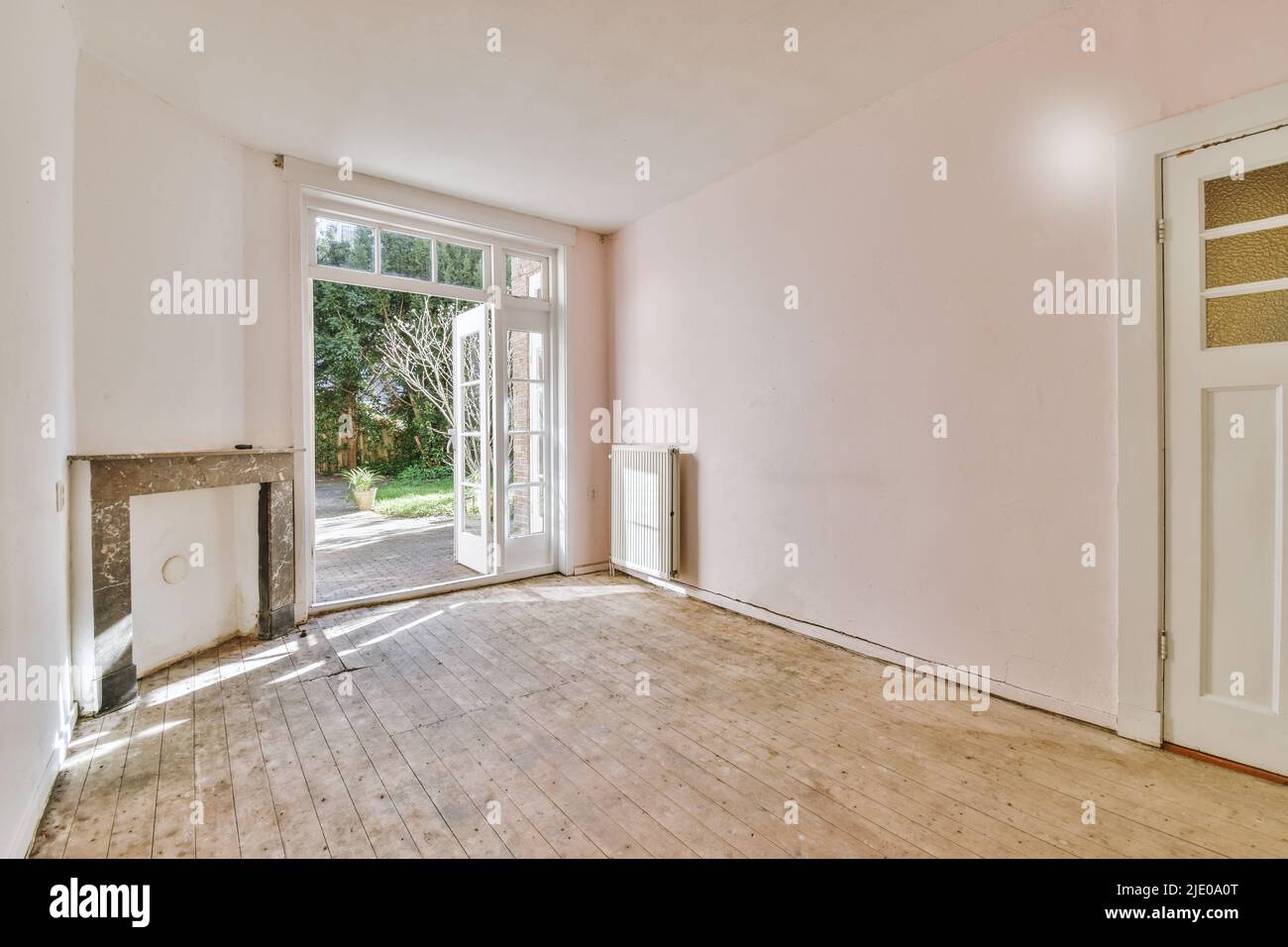 Modern counters with stools placed on wooden floor near fireplace in ...