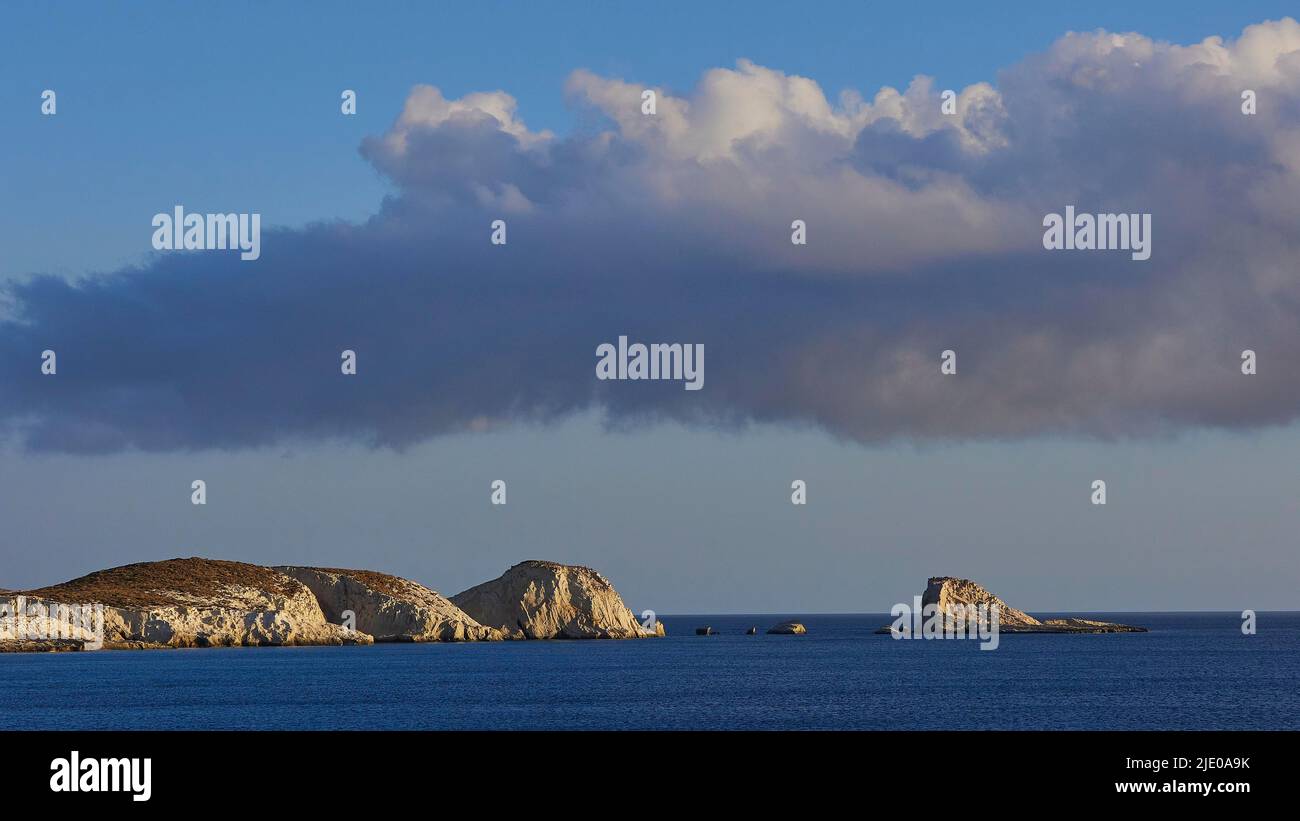 Morning light, tufa rocks, offshore islets, large grey-white cloud ...