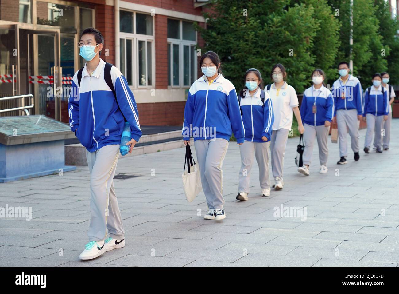 Beijing, China. 24th June, 2022. Students walk in line at an exam site ...