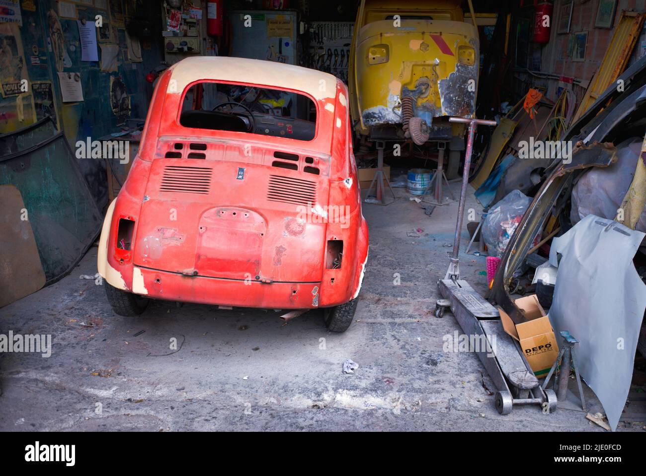 Historic old Fiat 500 in garage, car repair workshop, Castiglione di ...