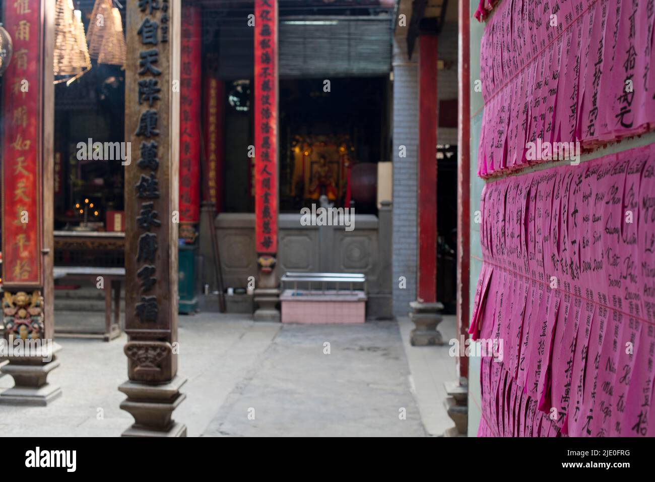 Prayer slip, black Chinese characters on pink tissue paper, in the ...