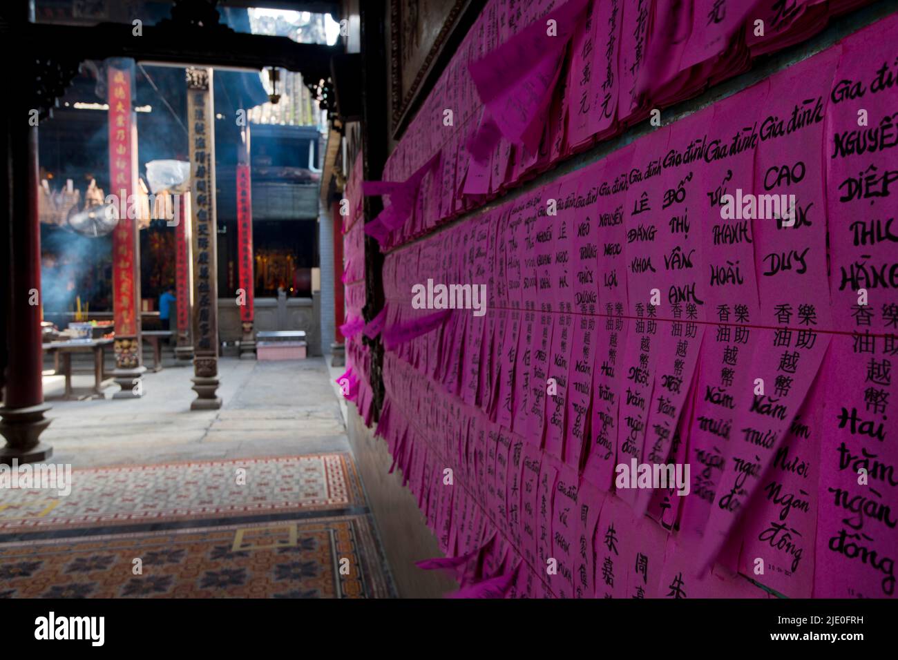 Prayer slip, black Chinese characters on pink tissue paper, in the ...