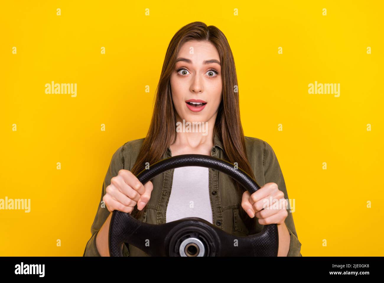 Portrait of good mood astonished impressed lady practice driving car ...