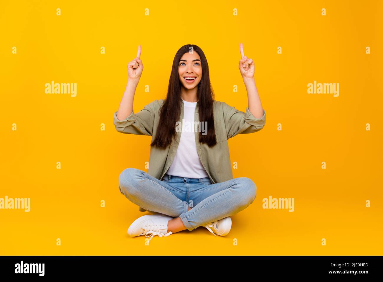 Full size photo of gorgeous satisfied lady sit floor look direct finger ...