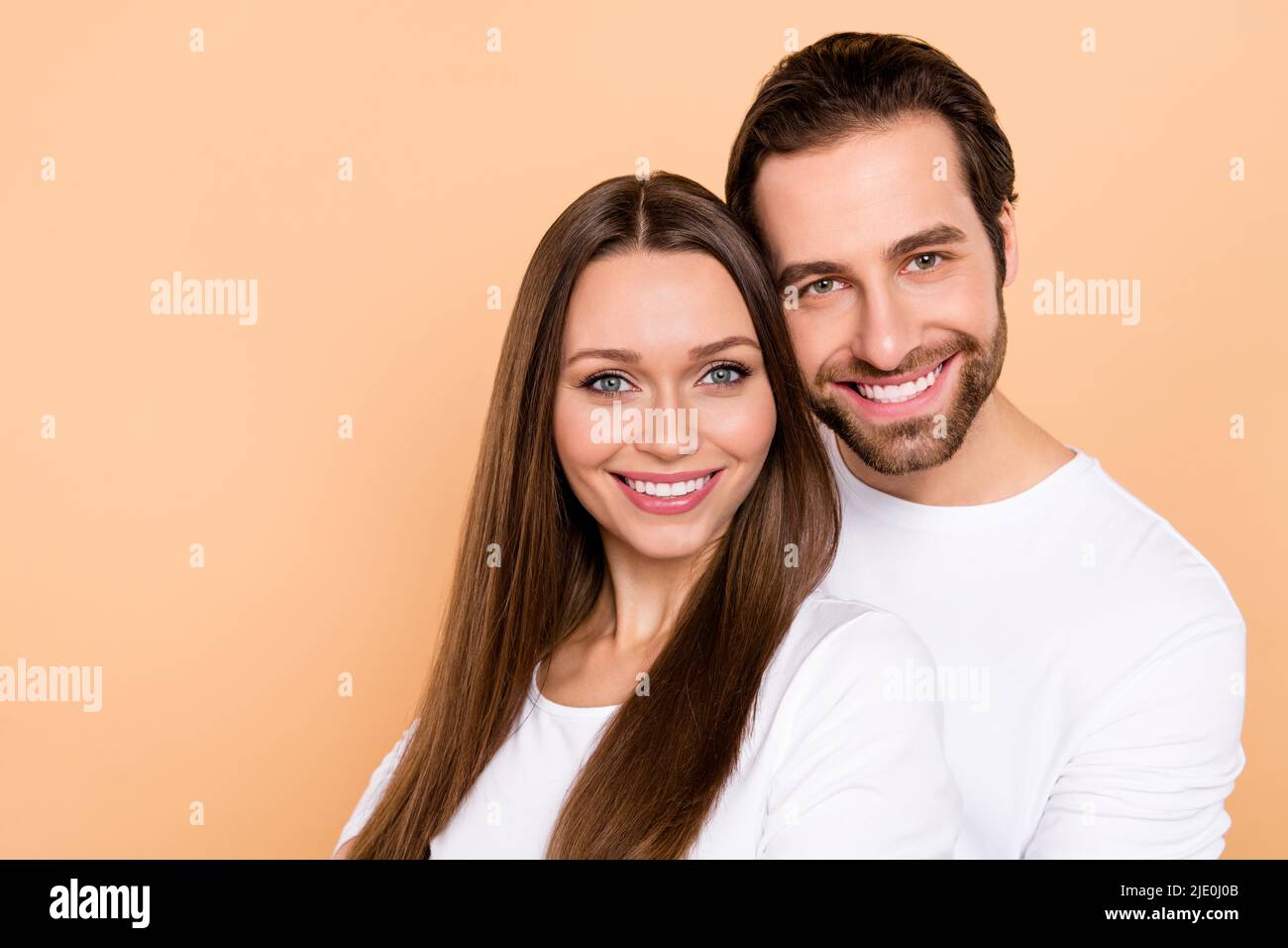 Photo of nice millennial brown hairdo couple hug wear white cloth ...