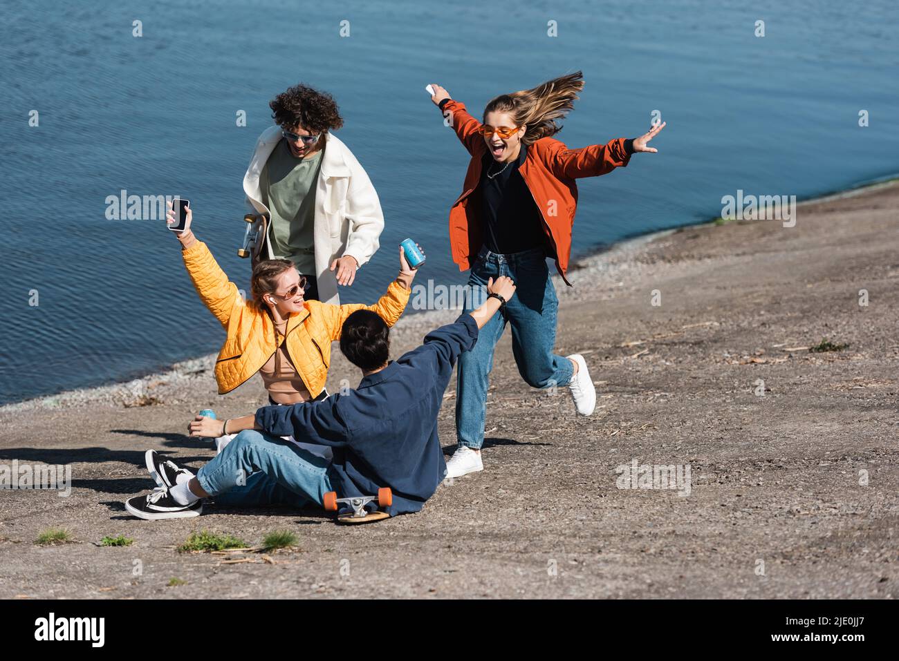 Happy men running towards women hi-res stock photography and images - Alamy