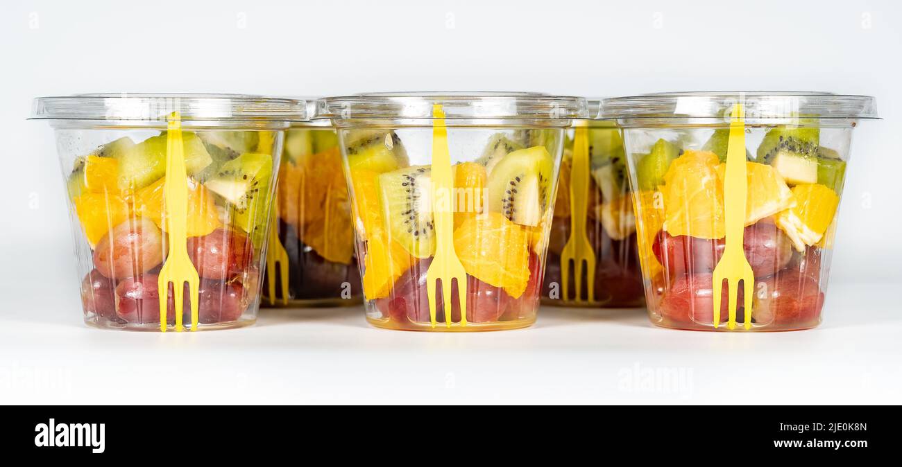 Peeled and cut fruit containers ready to eat in a healthy diet Stock ...