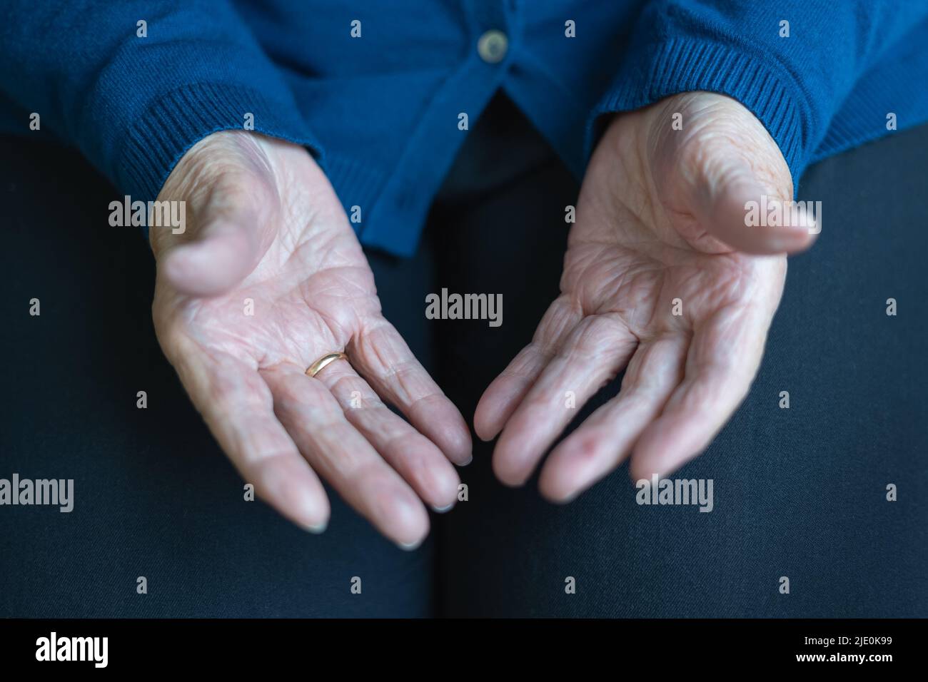Older woman's hands with palms up in a position to receive something ...