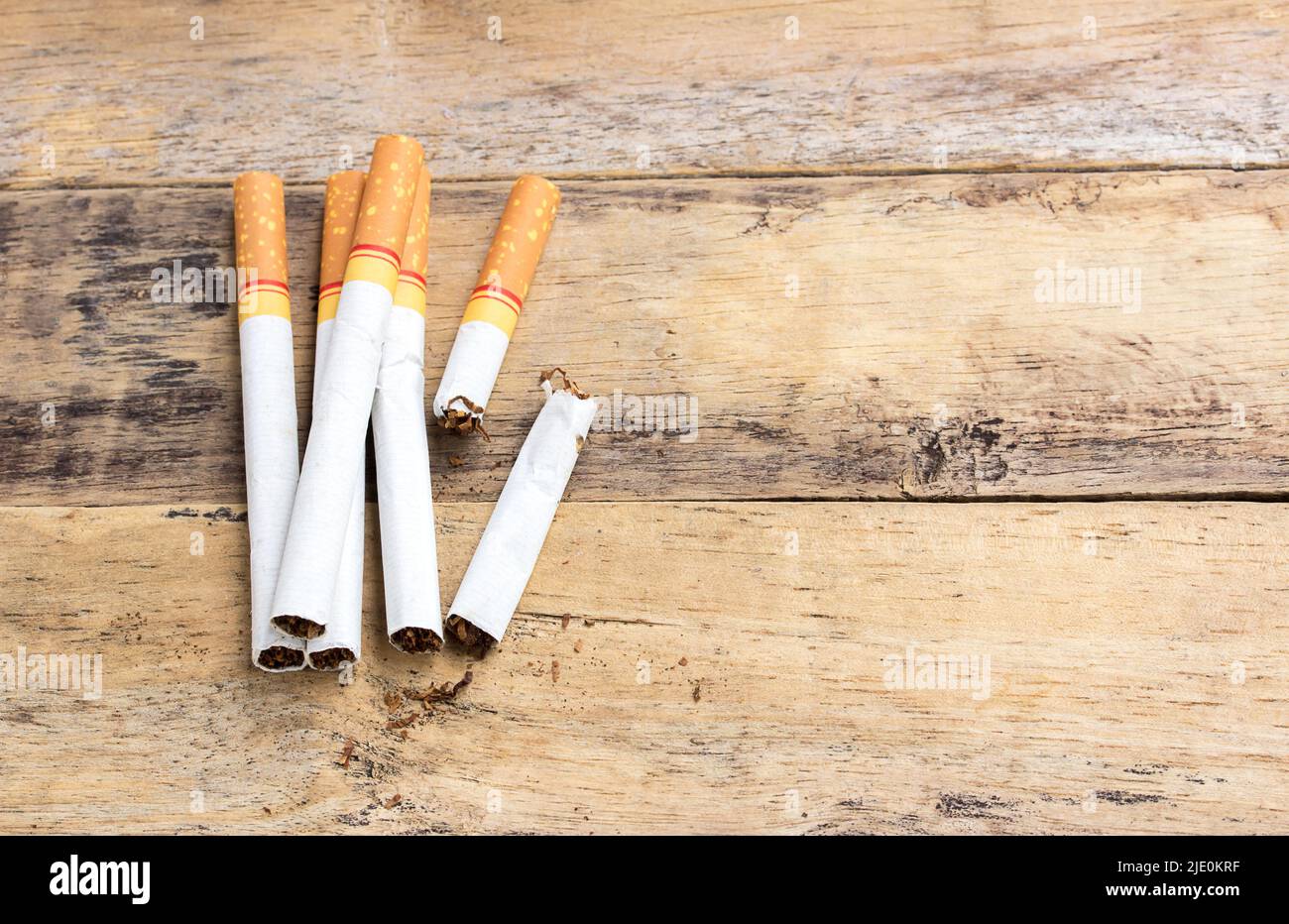 Tobacco cigarettes on a wooden table background. cigarette with health ...