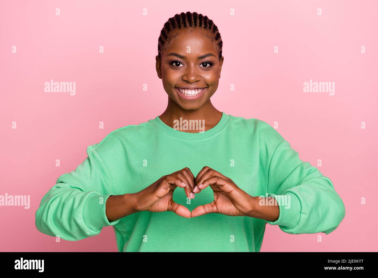 Portrait of cheerful pretty girl hands demonstrate heart symbol ...