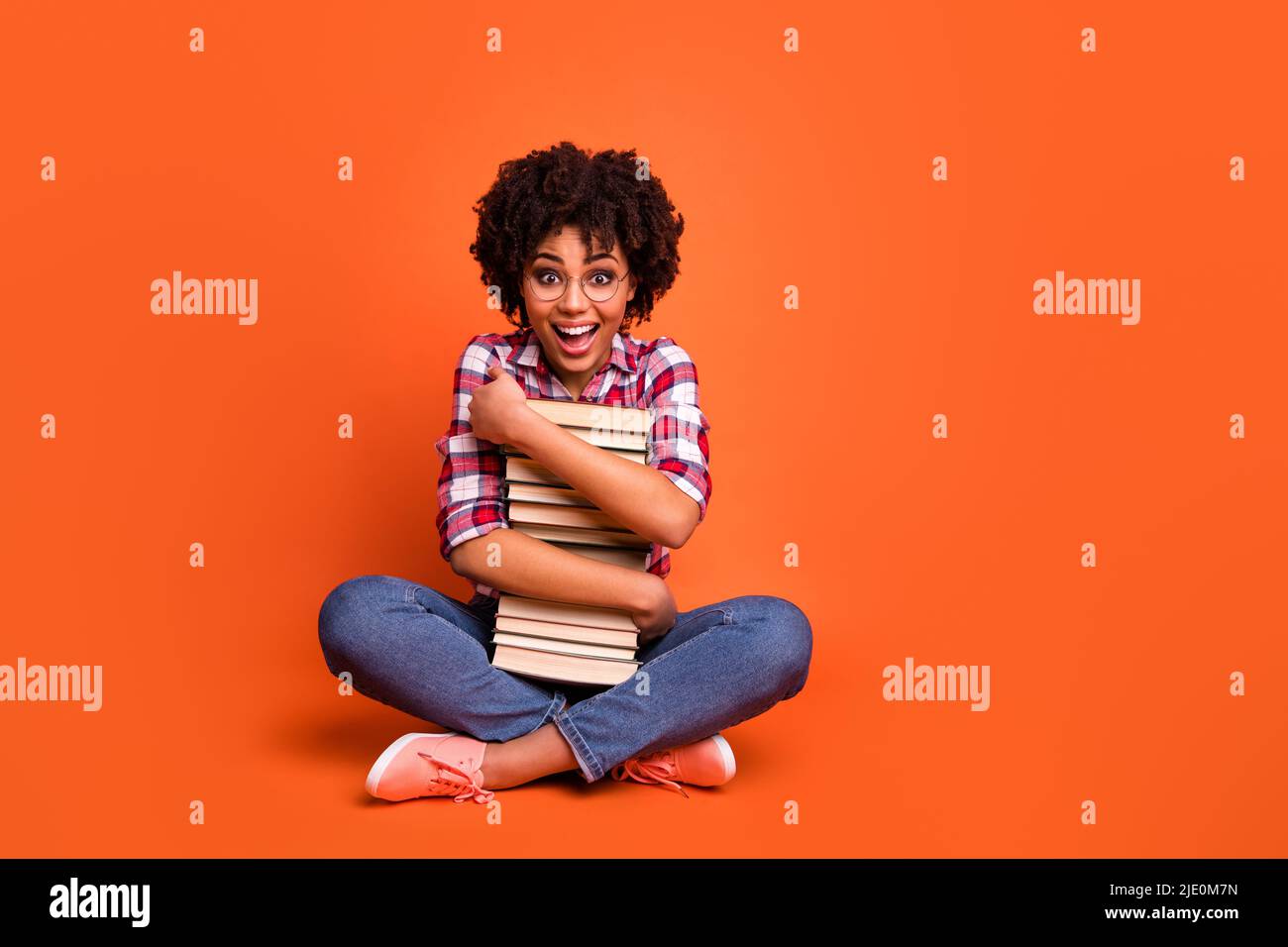 Full size photo of attractive excited girl hold cuddle stack book ...
