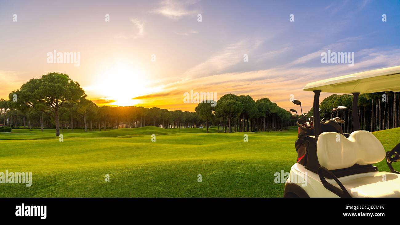 Panorama of golf cart on beautiful golf course at sunset Stock Photo ...