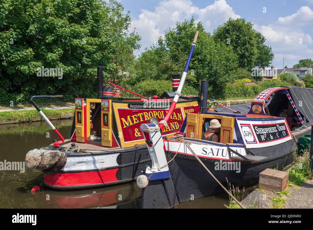 Brightly decorated canal narrowboats on the Bridgewater canal at Lymm ...