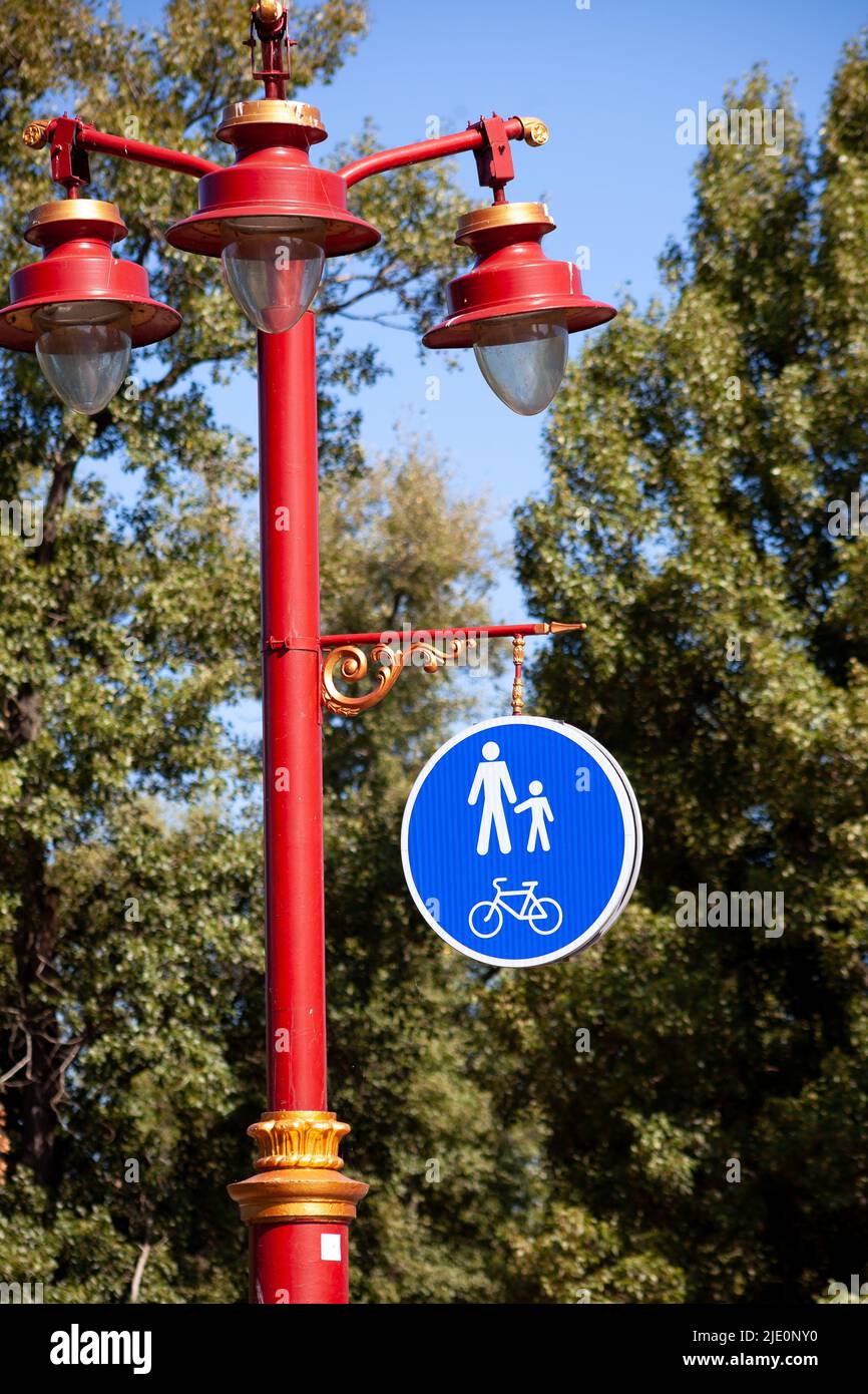 Road sign for pedestrian zone and cycling. Lantern in the city with a ...