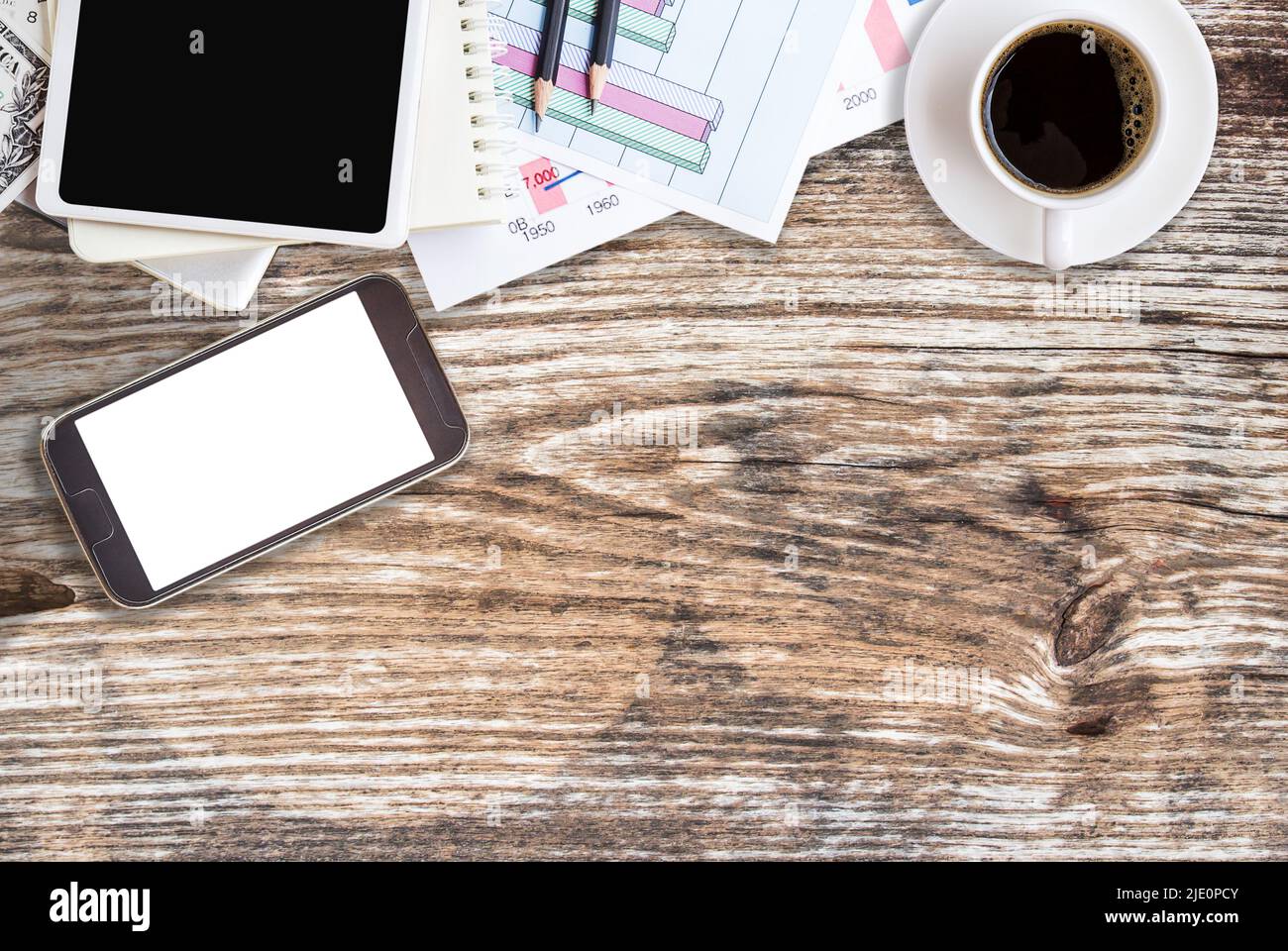 Vintage wood working table with smart phone, cup of coffee and supplies ...