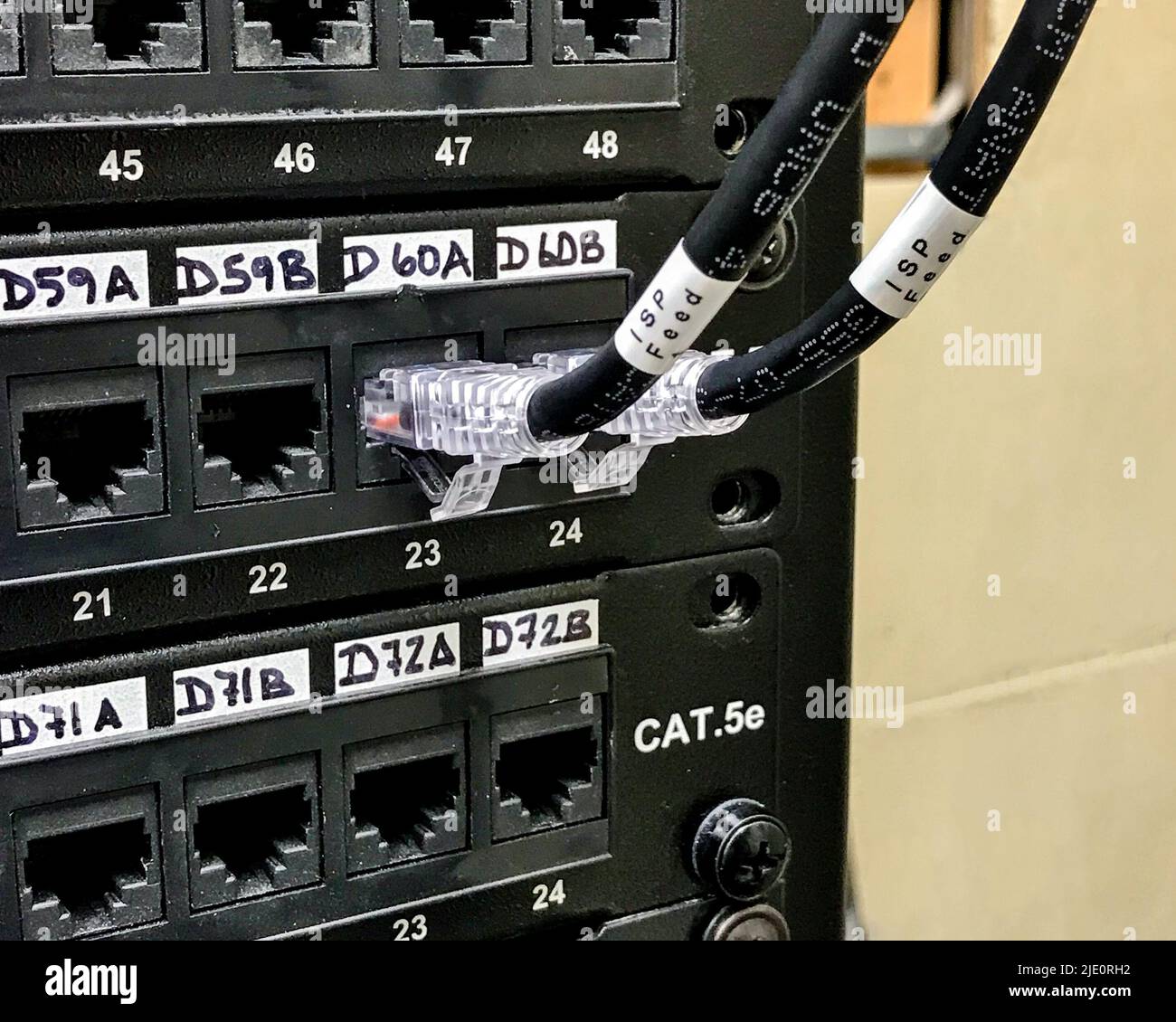 Enumerated ethernet patch panels with cables connected to the ports ...