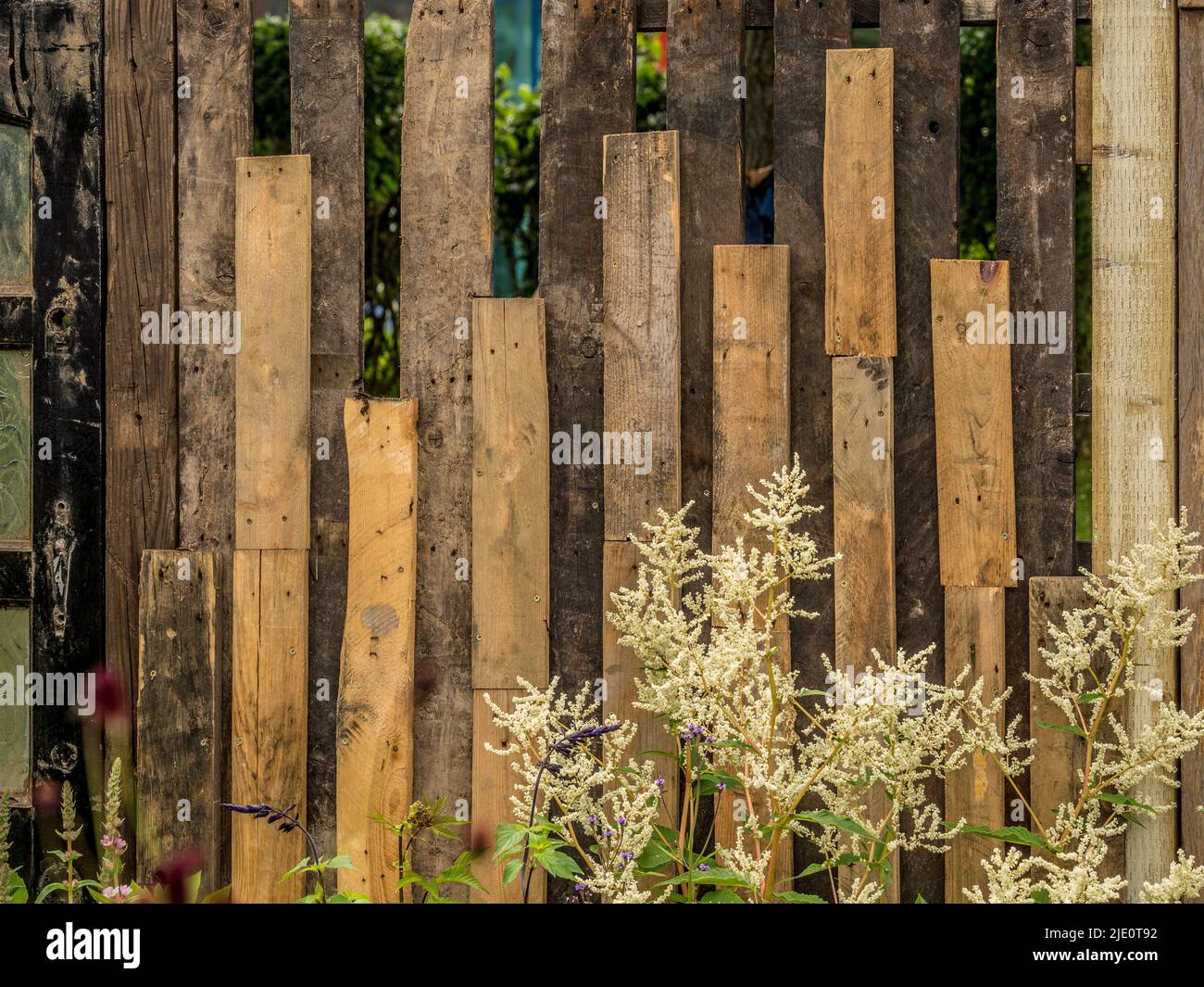 Wooden garden fence made from recycled old deconstructed pallets Stock ...