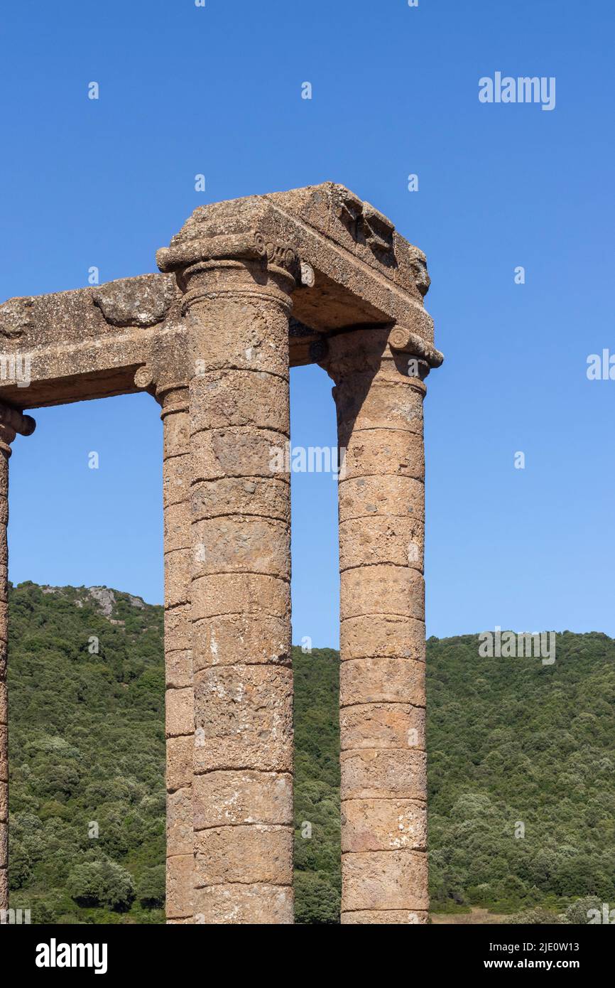 Vertical view of close up Roman temple under blue sky and green ...