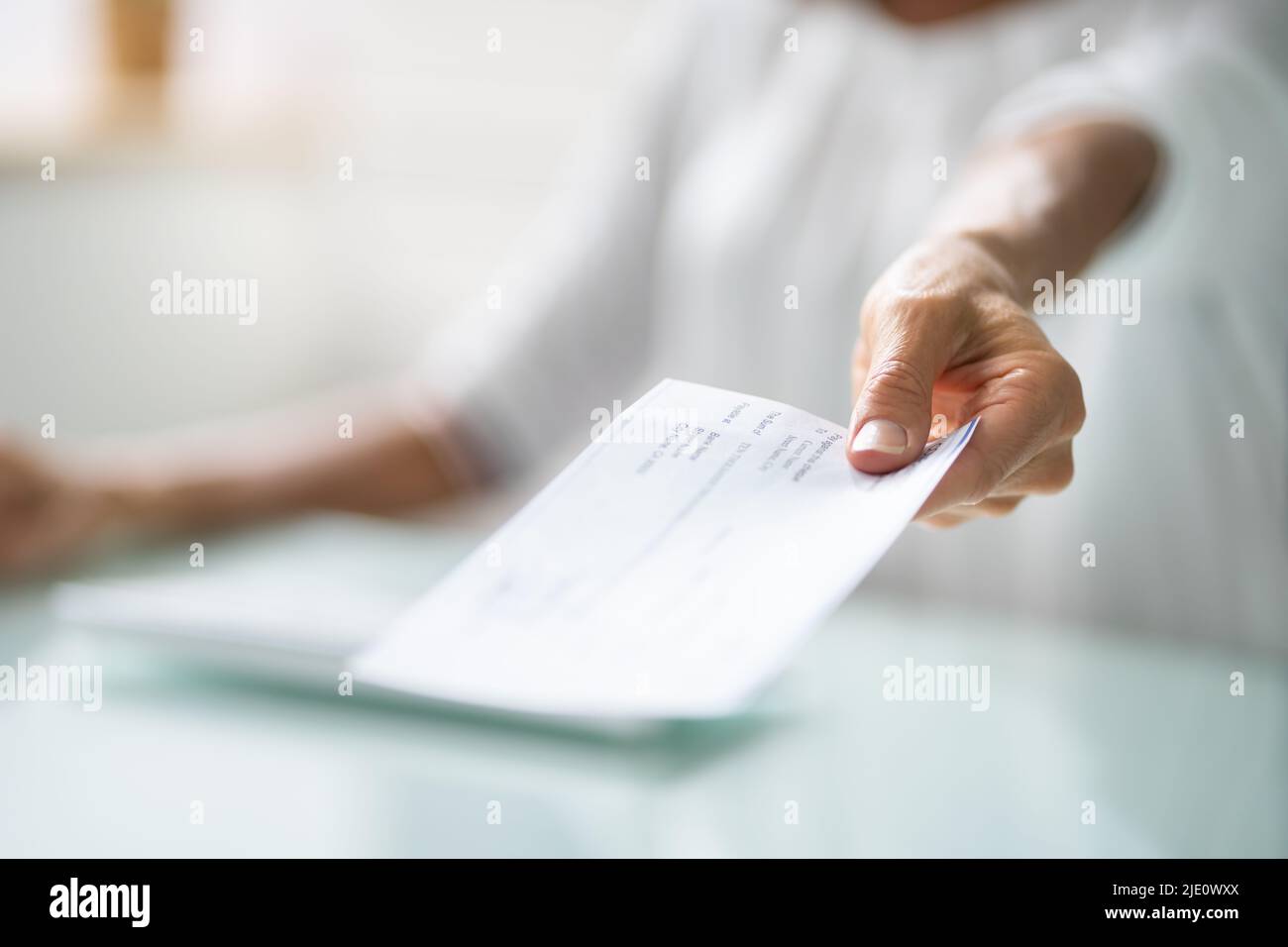 Close-up Photo Of Person's Hand Giving Cheque Stock Photo - Alamy
