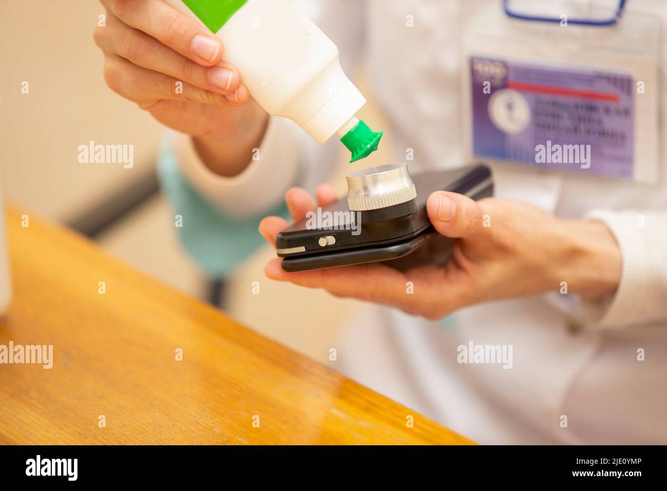 A dermatologist doctor treats with a solution of a modern device using ...