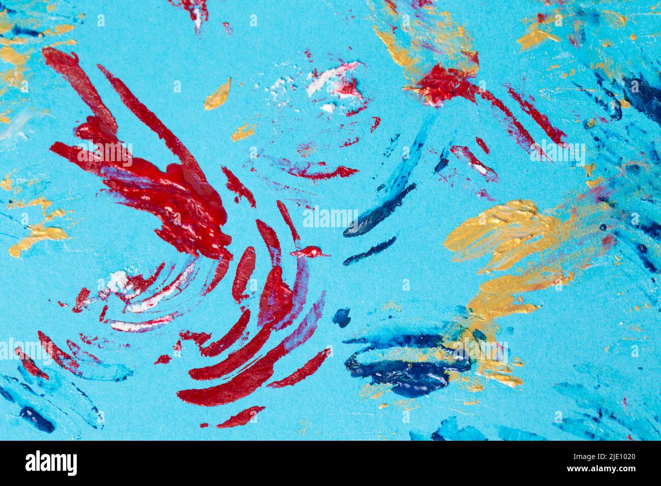 Multi-colored stains of paint on a blue background. Abstract background ...