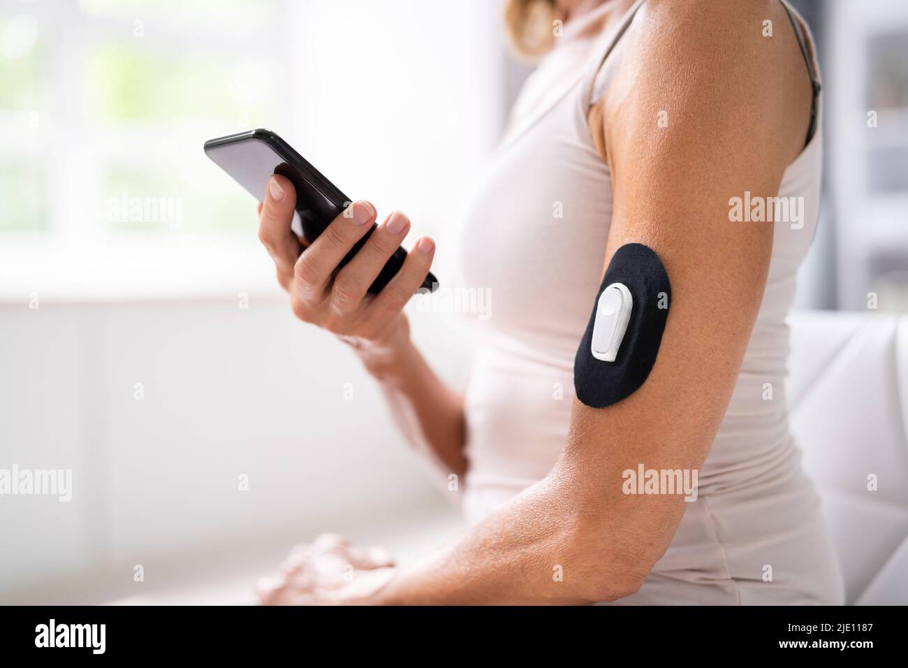 Woman Using Continuous Glucose Remote Monitor Diabetes Sensor Stock ...