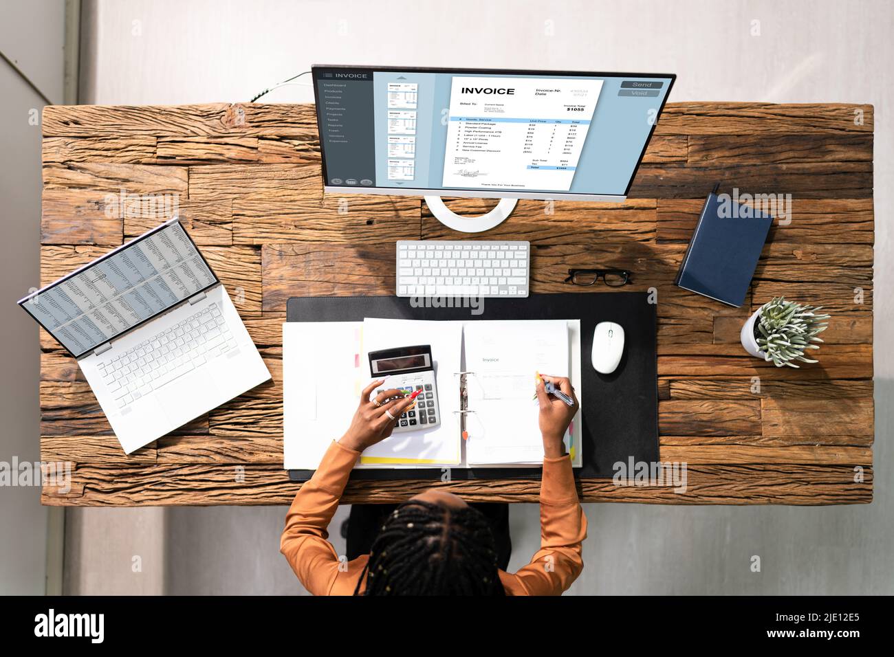 Female Accountant Calculating Tax In Front Of Computer At Desk Stock ...