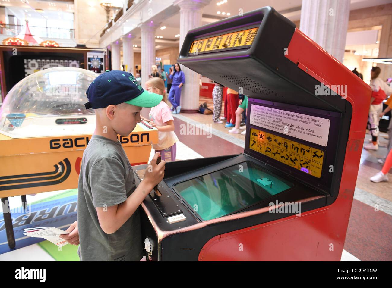 Moscow. The boy at the Bunnock game machine at the Festival of the 90th ...