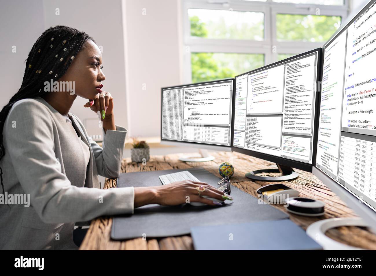 African American Coder Using Computer At Desk Web Developer Stock african-american-coder-using-computer-at-desk-web-developer-stock