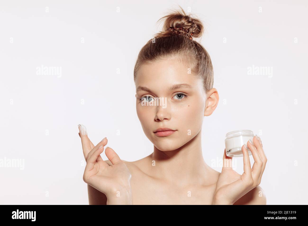 Portrait of young female fashion model without makeup isolated on white ...