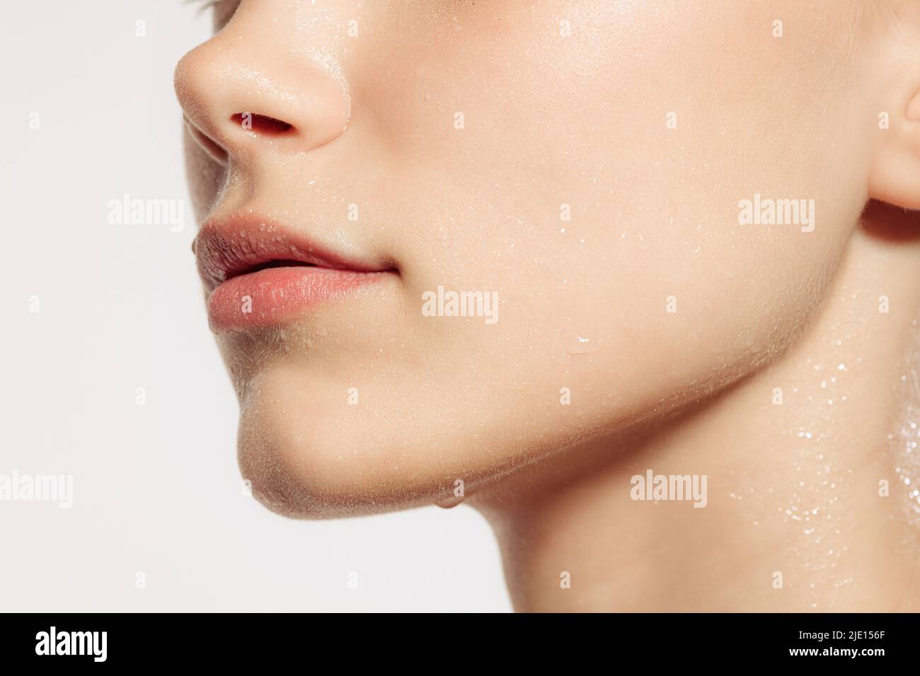 Closeup female lips, cheeks and nose isolated over white studio ...