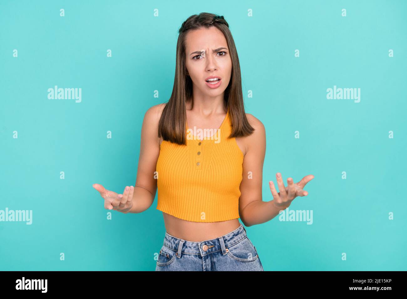 Photo of unhappy upset young woman shrug shoulders bad mood negative ...