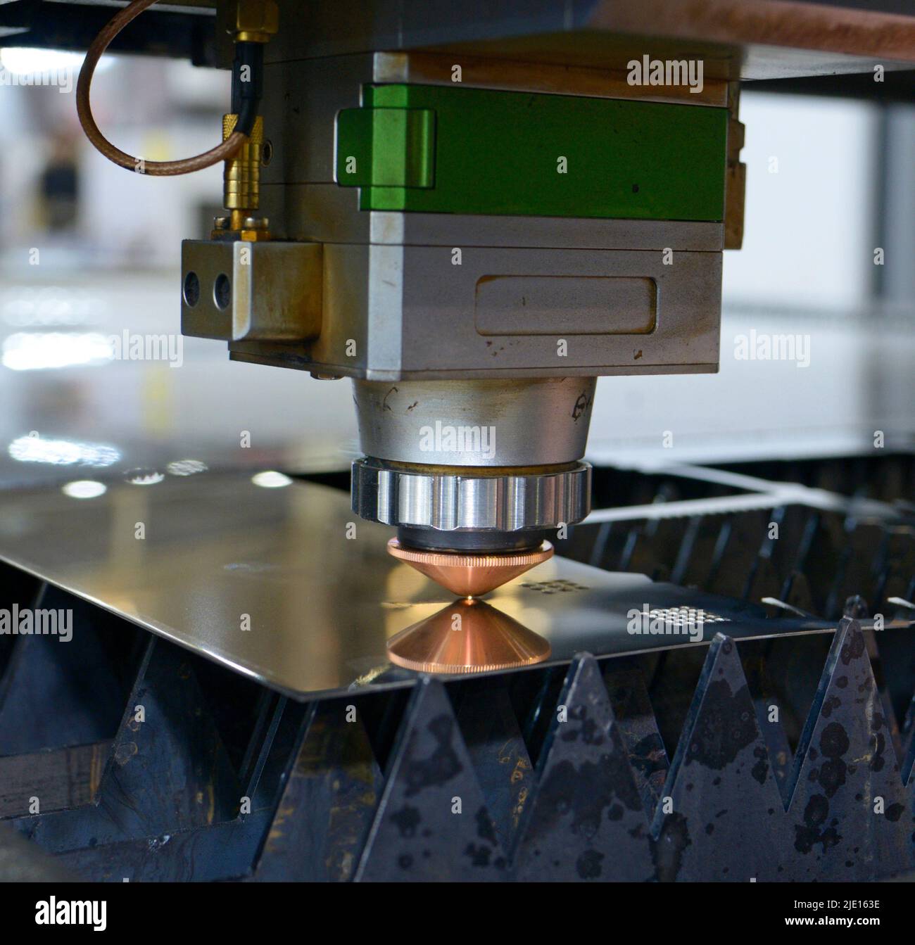 Laser machine cutting metal sheet, sparks coming Stock Photo - Alamy