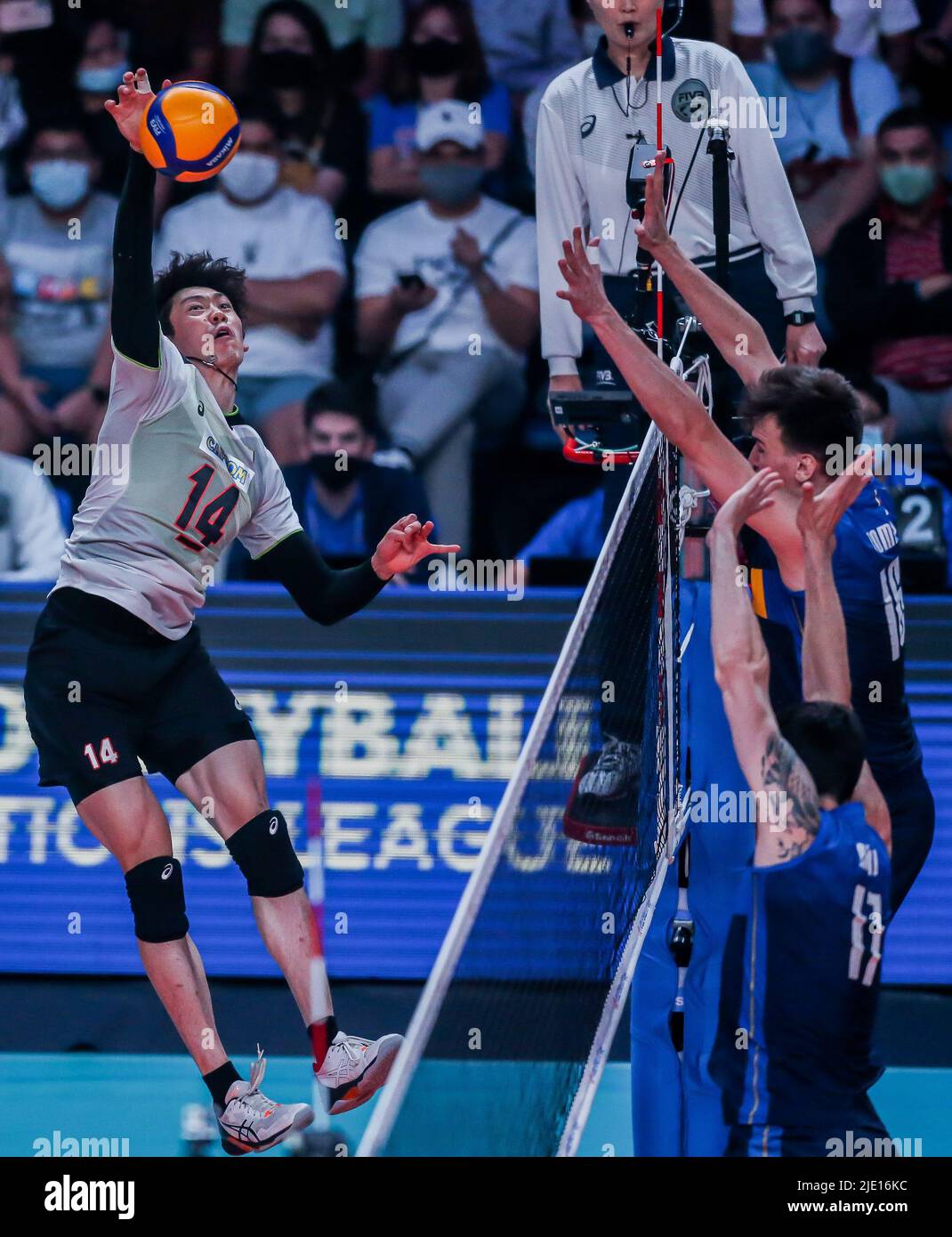 Quezon City. 24th June, 2022. Japan's Yuki Ishikawa (L) spikes the ball ...