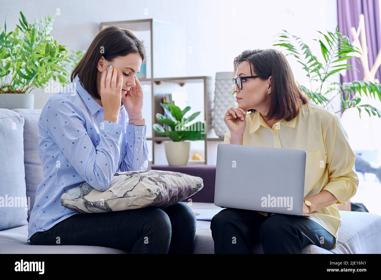 Upset sad young woman at session with psychologist Stock Photo - Alamy