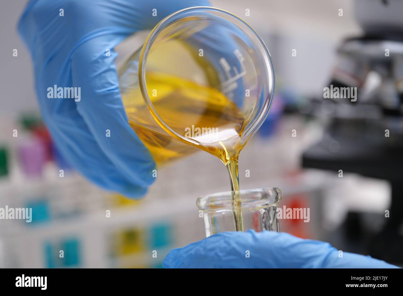 Pouring and mixing chemicals closeup. Laboratory and scientific ...
