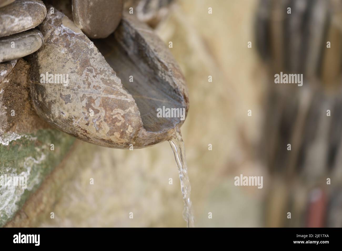 Old stone and fountain with spring water flowing into pool Stock Photo ...