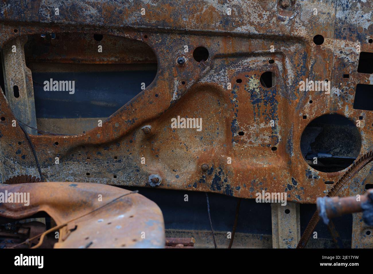 Burnt old rusty car parts. Looting, arson and terrorism Stock Photo - Alamy
