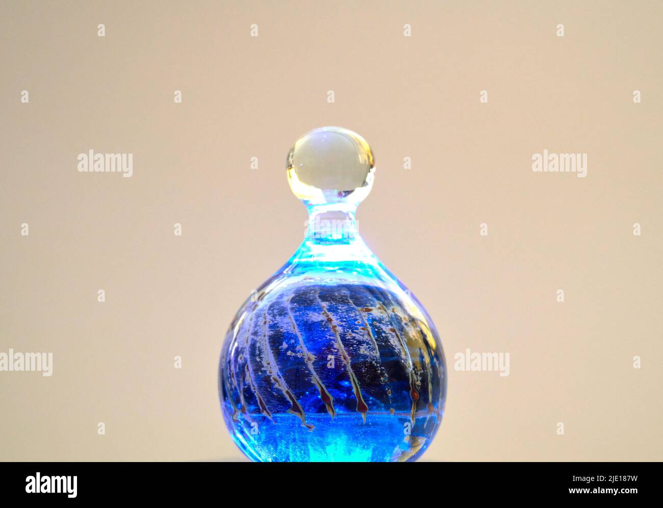 Colored glass paper weight on a plain background Stock Photo - Alamy