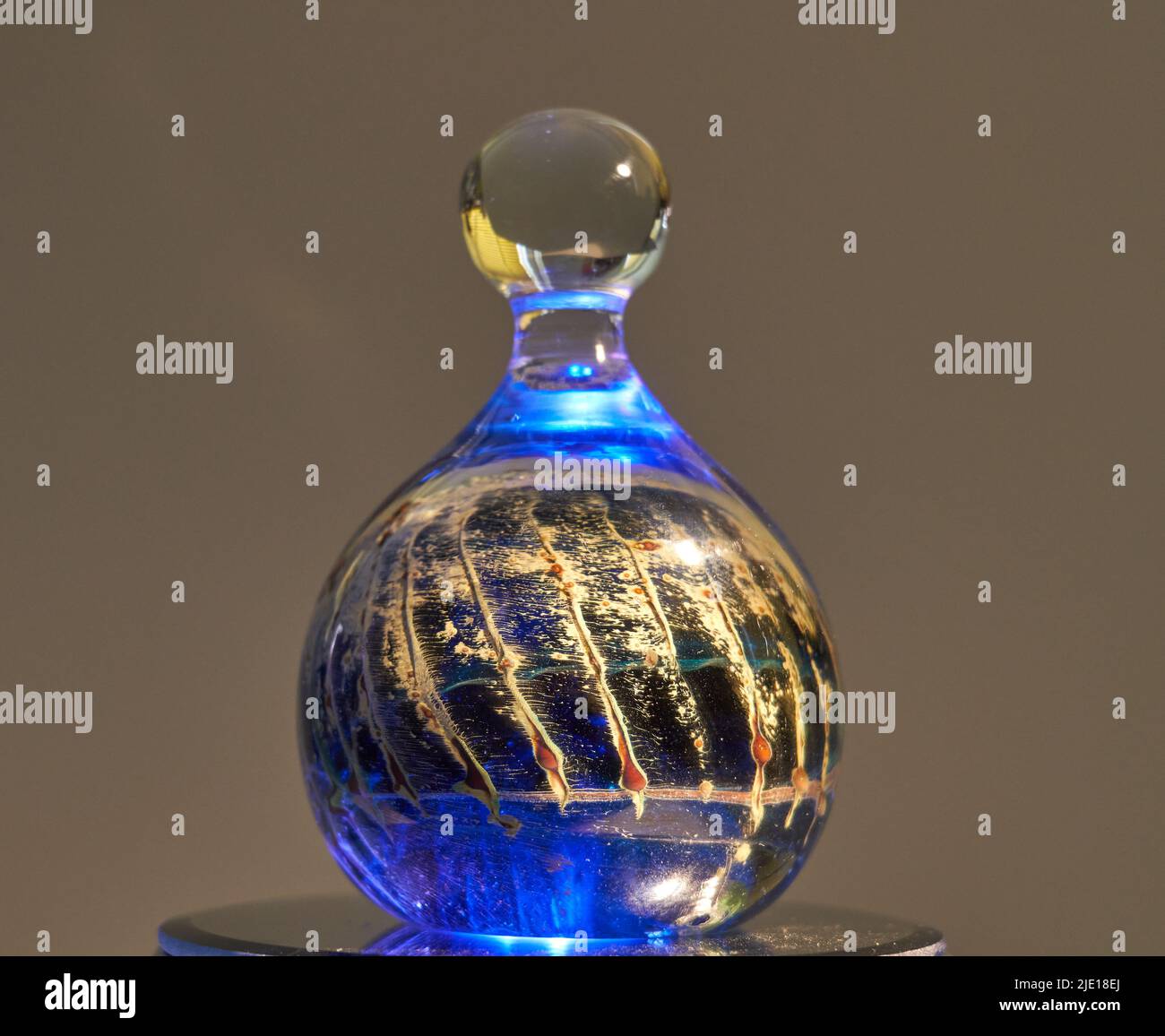 Colored glass paper weight on a plain background Stock Photo - Alamy