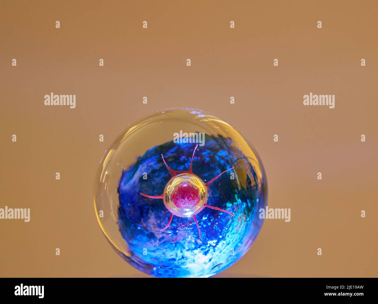 Colored glass paper weight on a plain background Stock Photo - Alamy
