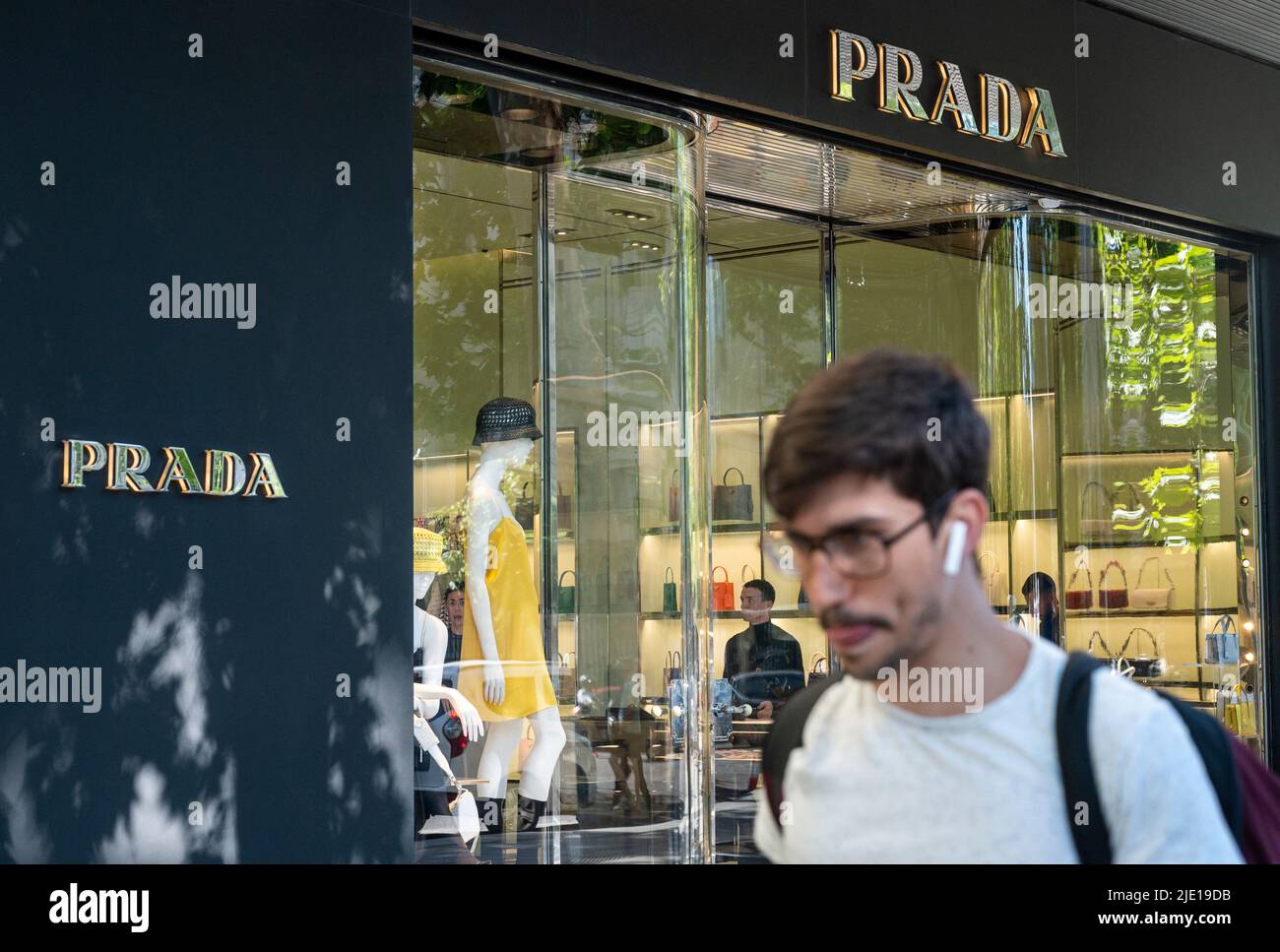 A pedestrian walks past the Italian luxury fashion company Prada store ...