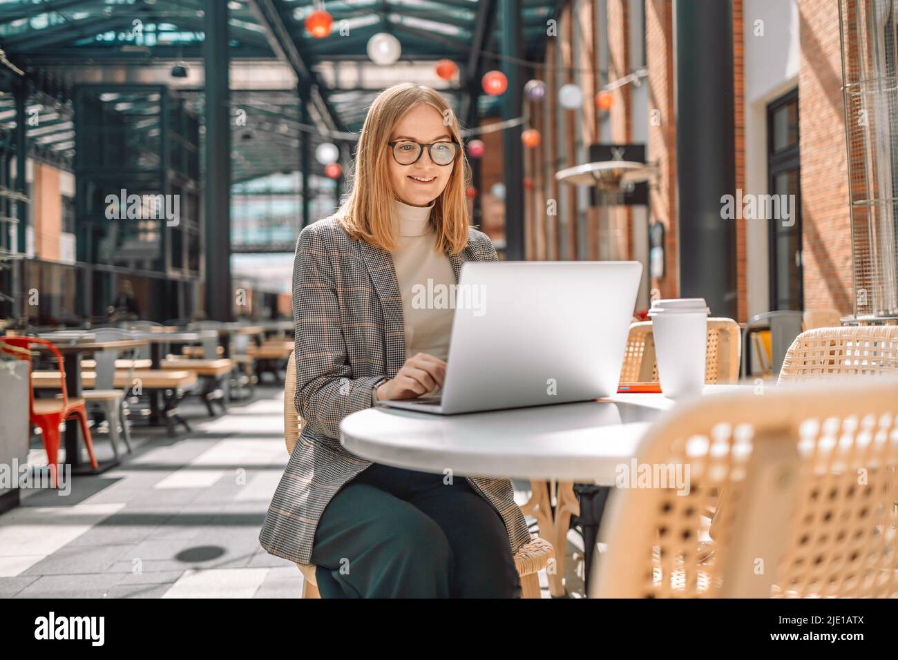 Attractive female freelancer woman working at pc laptop while sitting ...