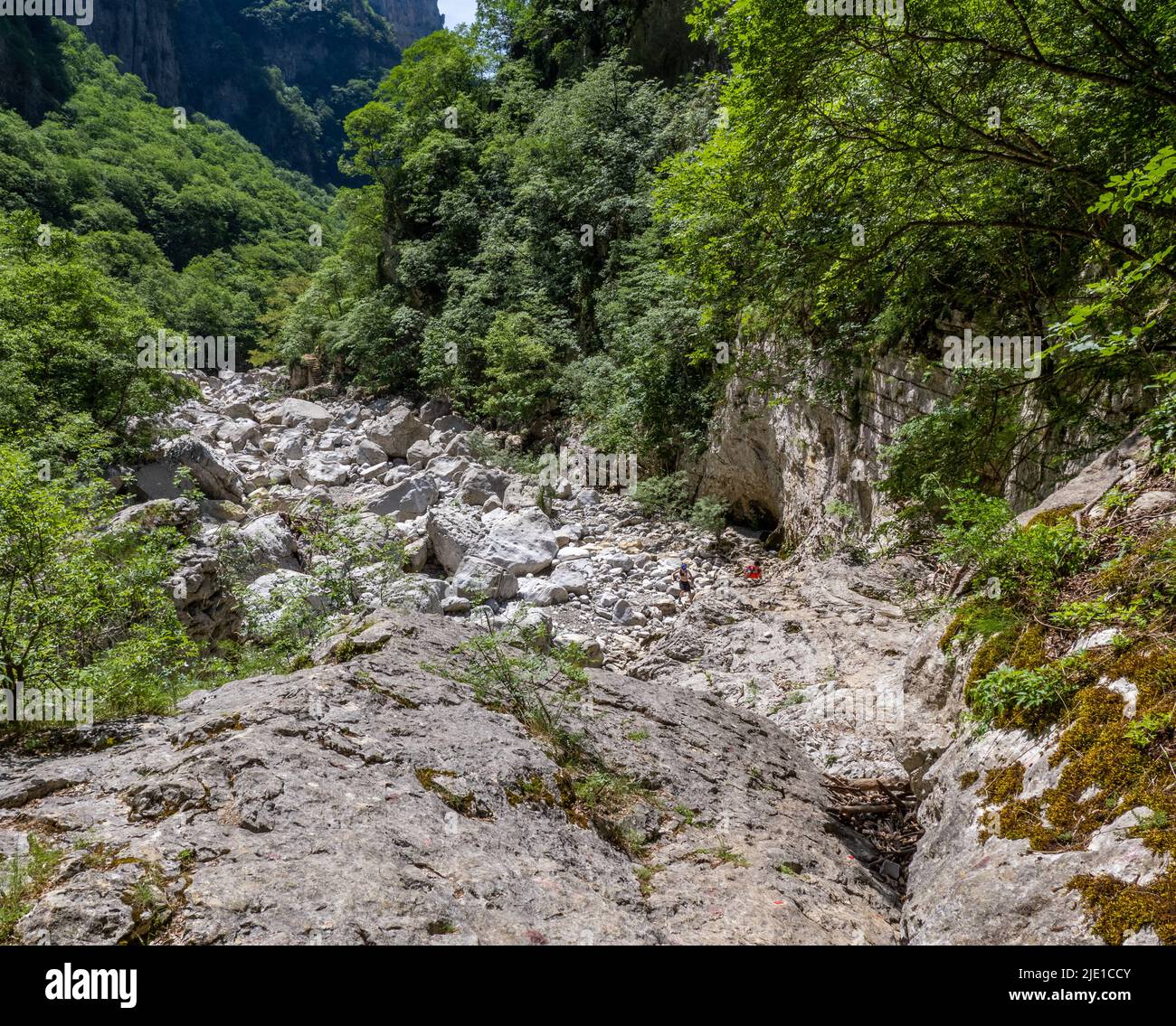 Walkers negotiating the rocky river bed section of the Vikos Gorge ...