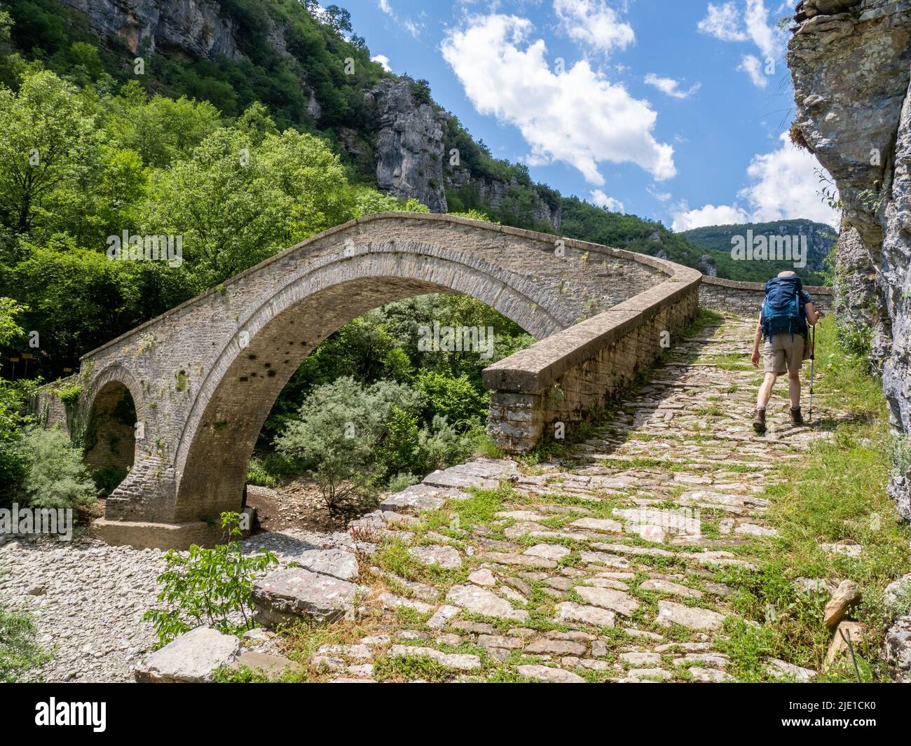 Crossing the beautiful double-arched Misios bridge below the village of ...