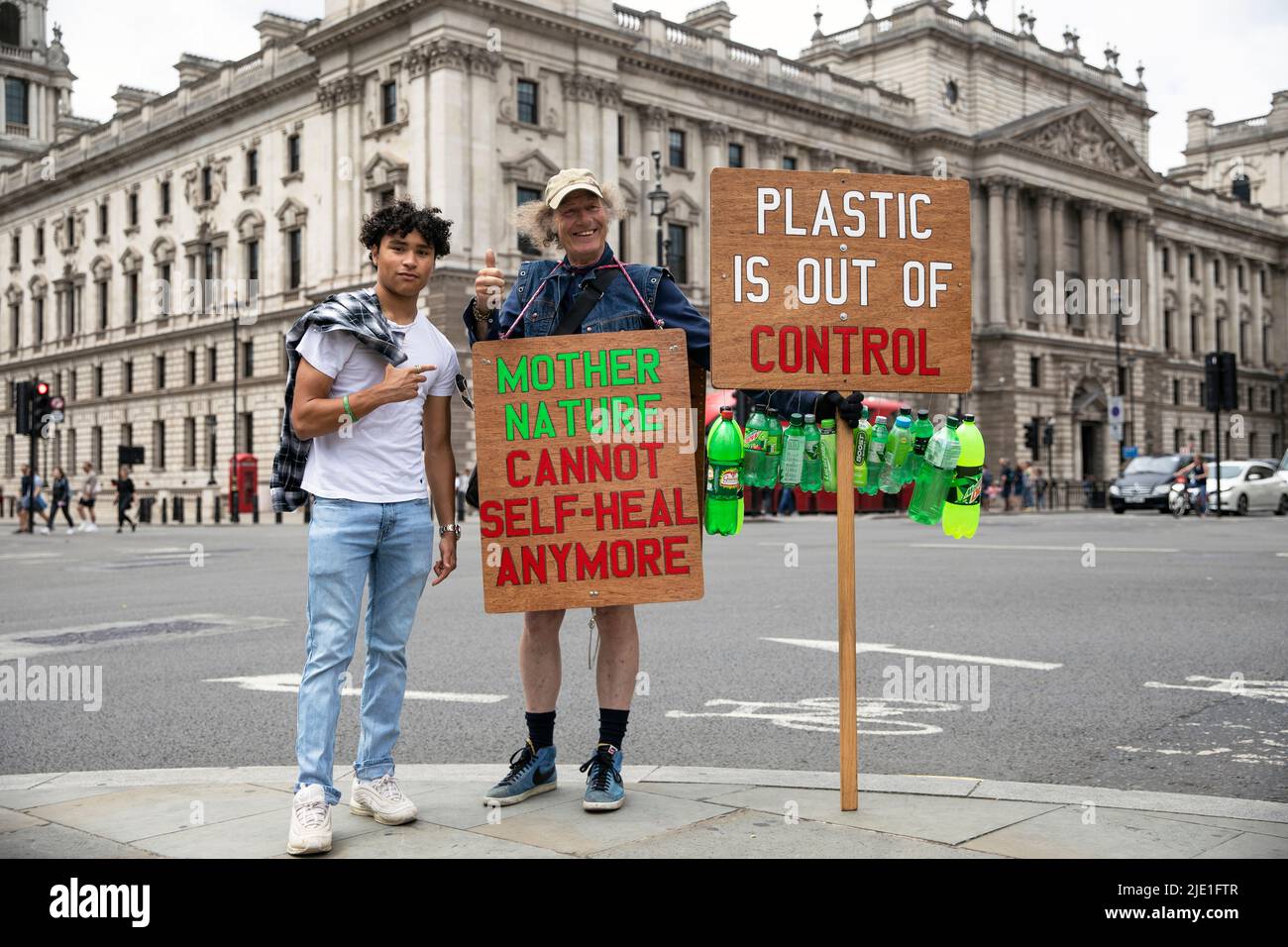 Nicholas Herrera, 15, (left) poses for a picture with Climate protester ...