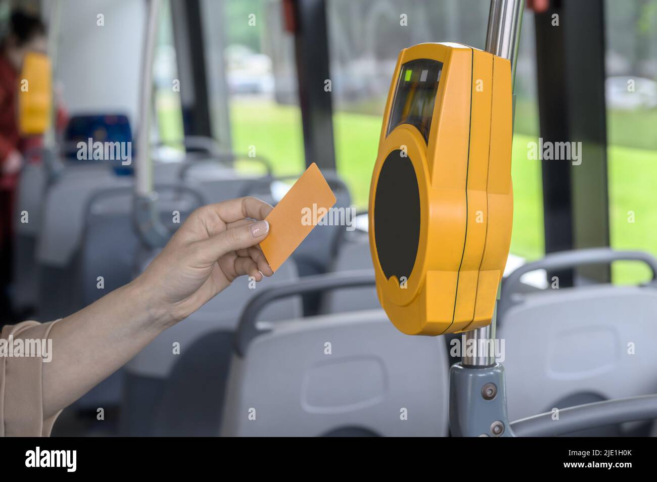 the passenger pays contactless with a bank card for public transport in ...